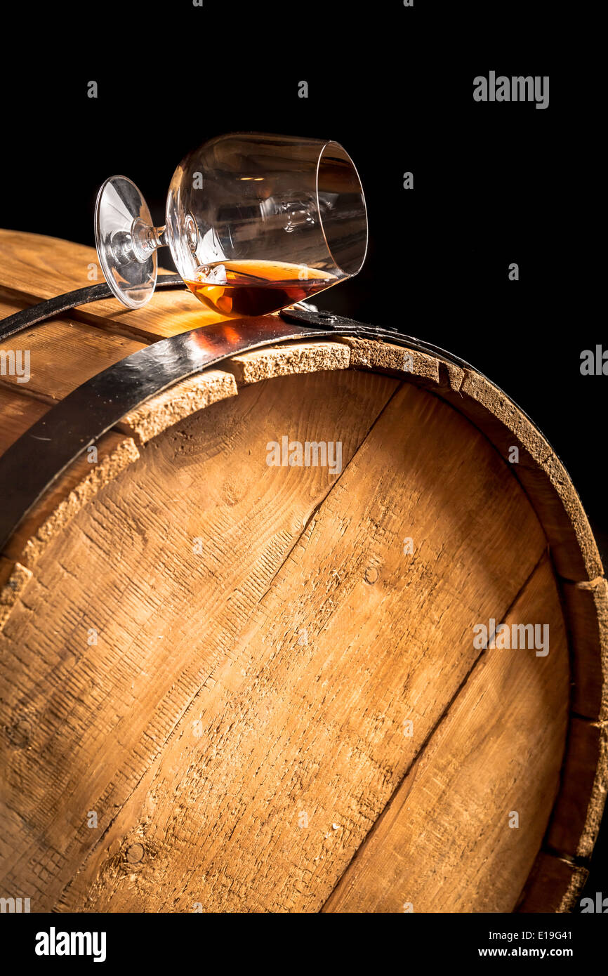 Glass of cognac on the old wooden barrel Stock Photo - Alamy