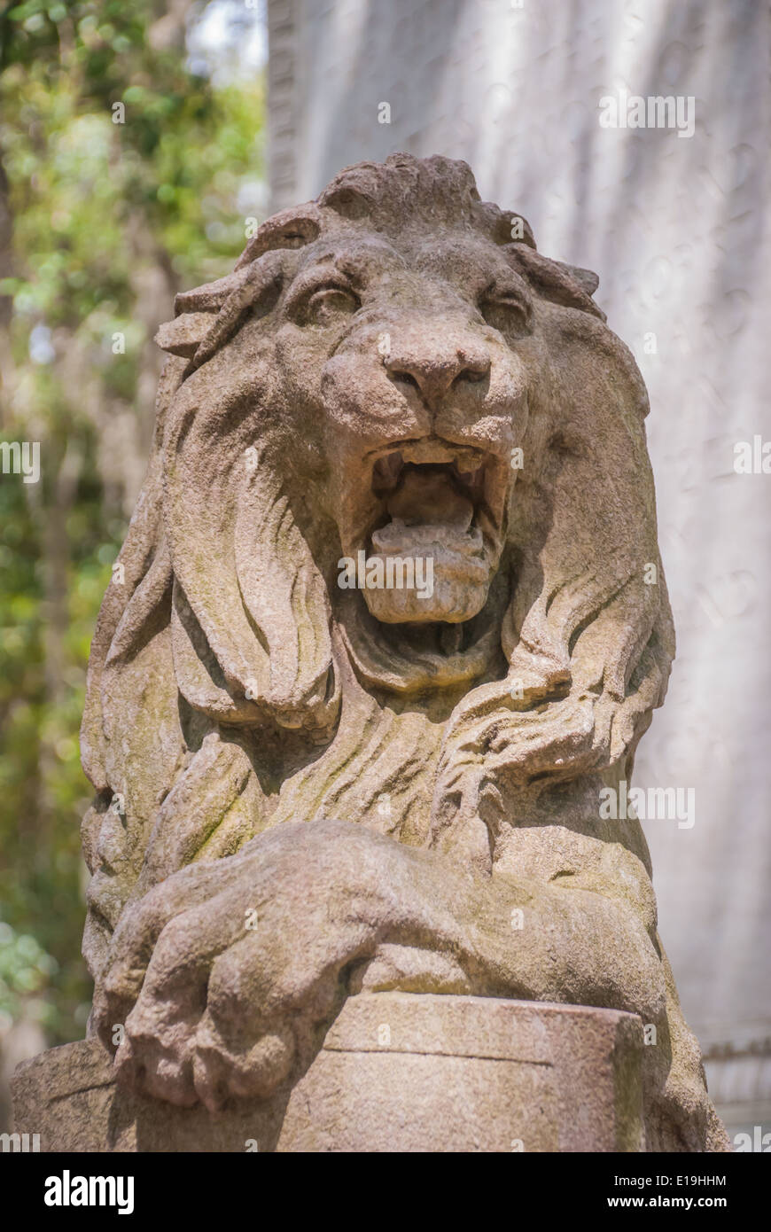 Stone Lion Statue Guards Urban Garden Stock Photo - Alamy
