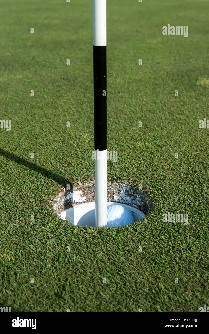 Black and White Golf Pin Marks Hole at End of Course Stock Photo - Alamy