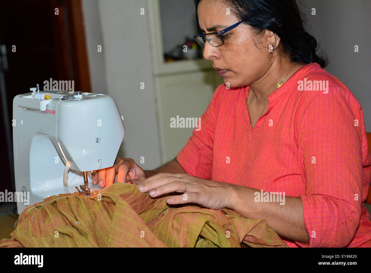 Indian woman sewing hi-res stock photography and images - Alamy