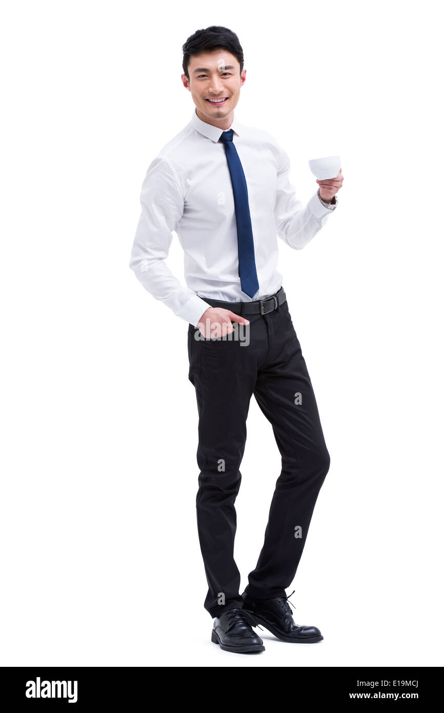 Young businessman drinking tea Stock Photo - Alamy