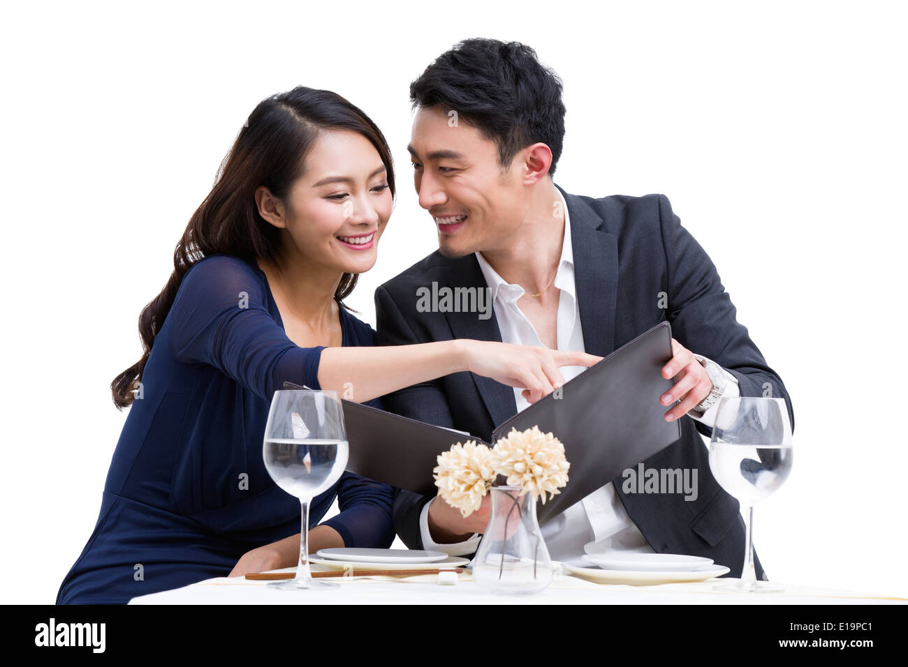 Young couple reading menu in restaurant Stock Photo - Alamy