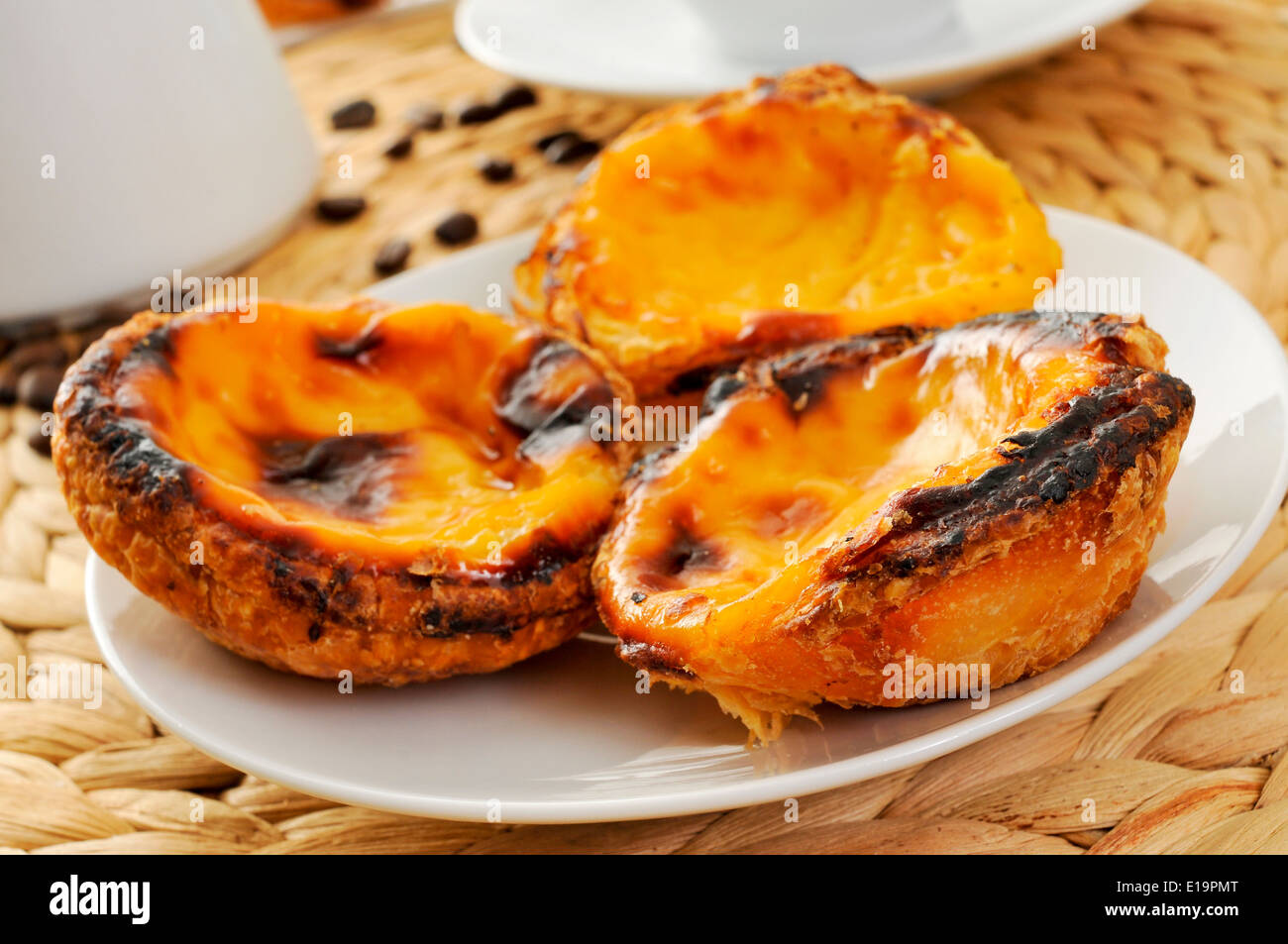 a plate with pasteis de nata, typical Portuguese egg tart pastries on a ...