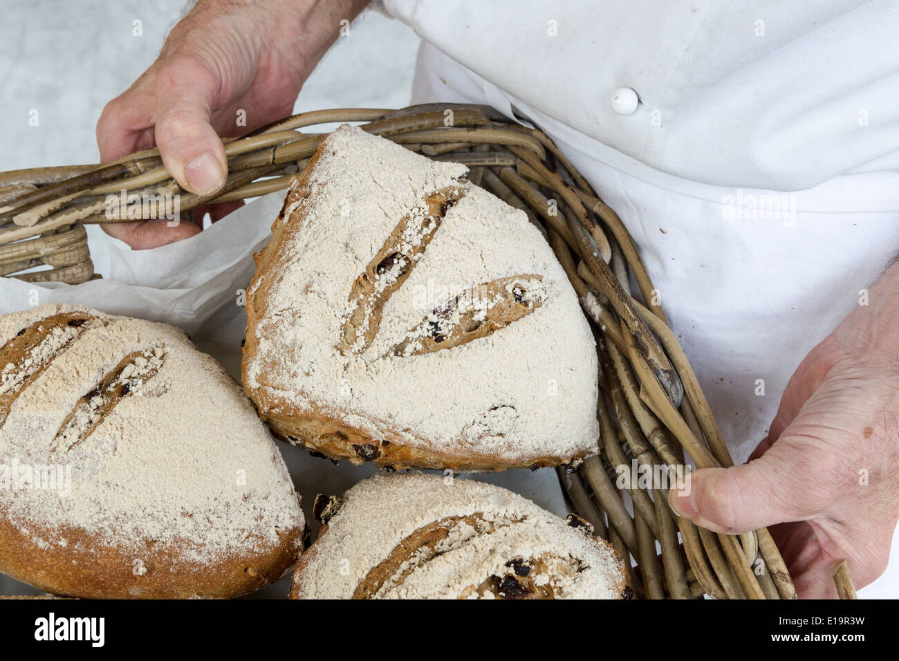baker holding basket of freshly baked bread Stock Photo - Alamy