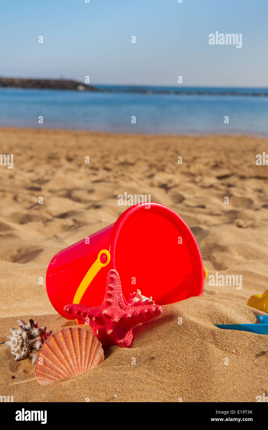 bucket with plastic beach toys in sand Stock Photo - Alamy