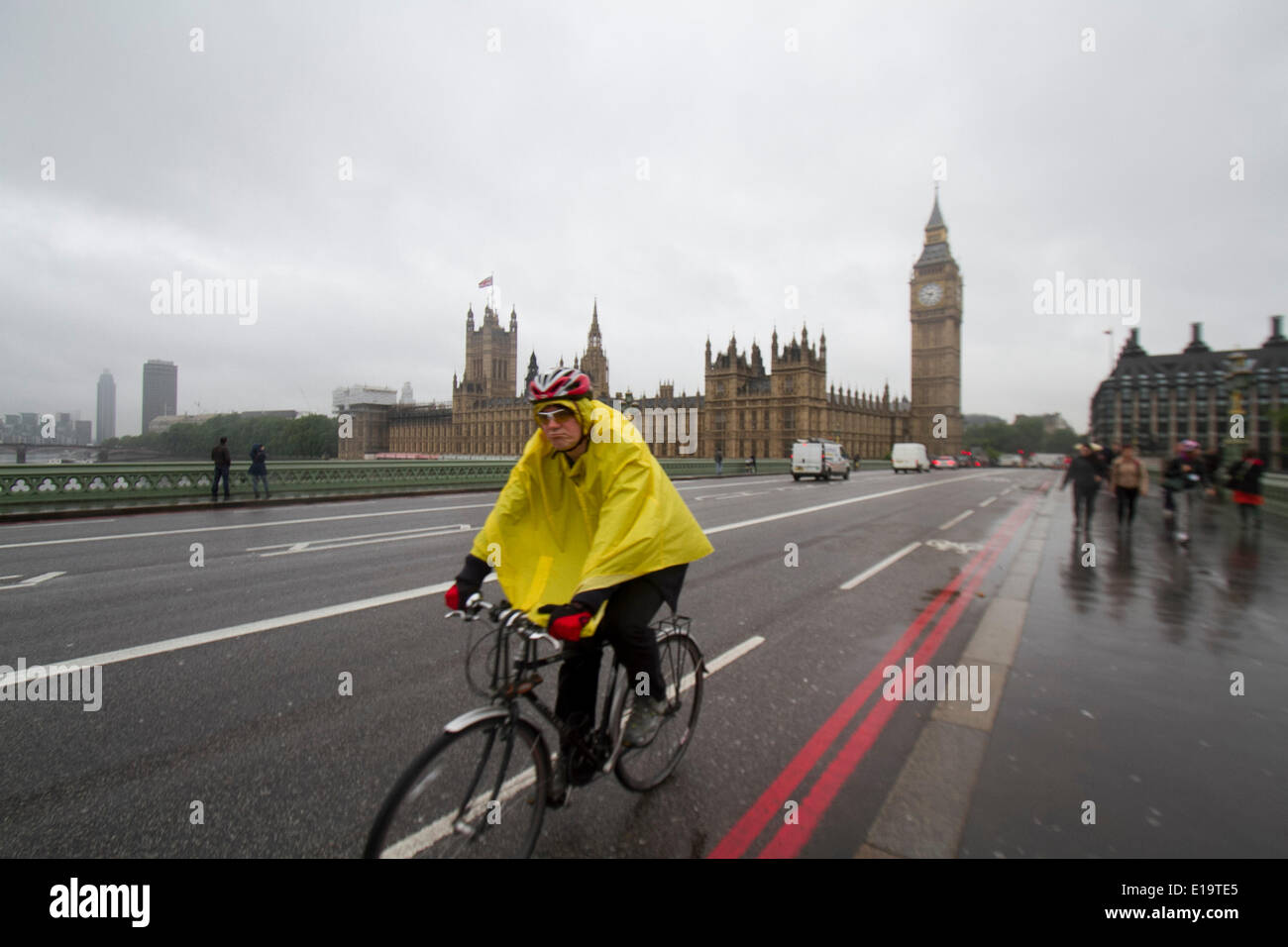 Westminster London, UK. 28th May 2014. A cyclist with a rain poncho ...