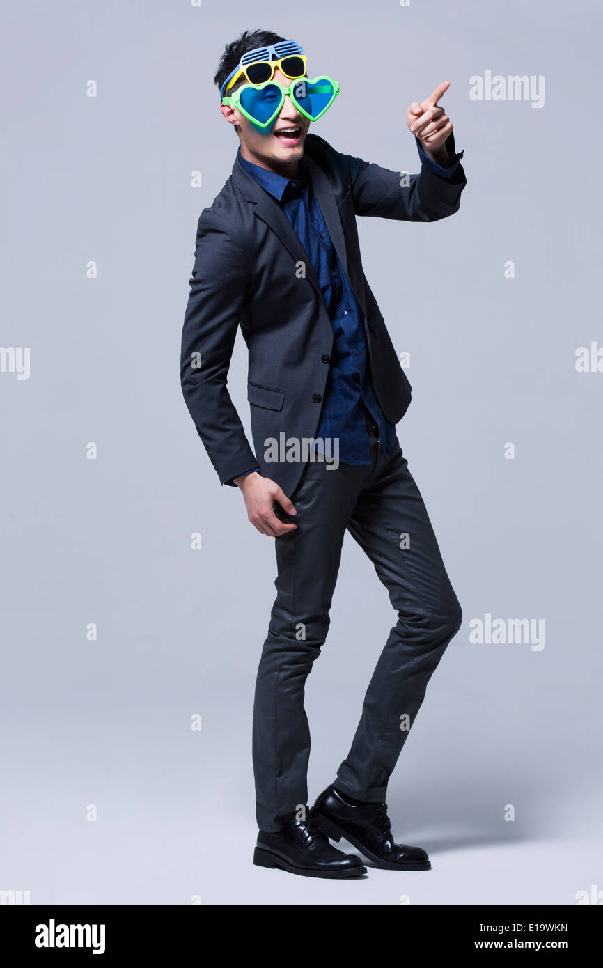 Hip young man wearing multiple pairs of sunglasses Stock Photo - Alamy