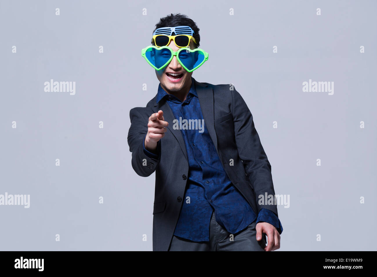 Hip young man wearing multiple pairs of sunglasses Stock Photo - Alamy