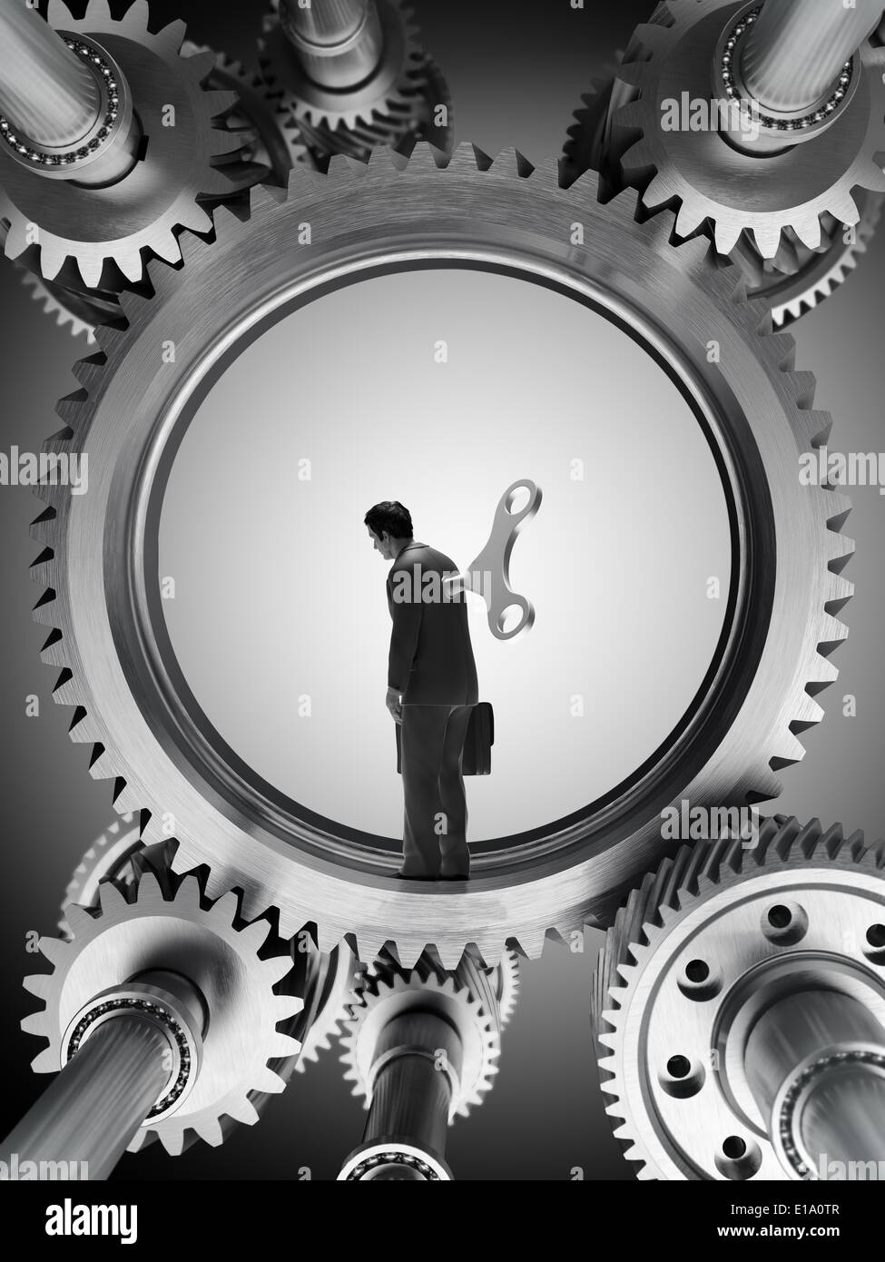 A man inside a machine with a wind-up key Stock Photo - Alamy