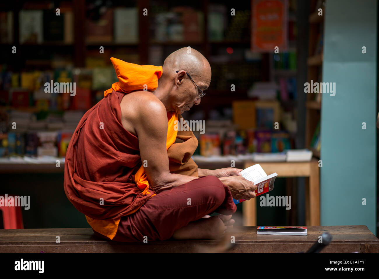 This Buddhist monk takes a break from daily duties to read a book at ...