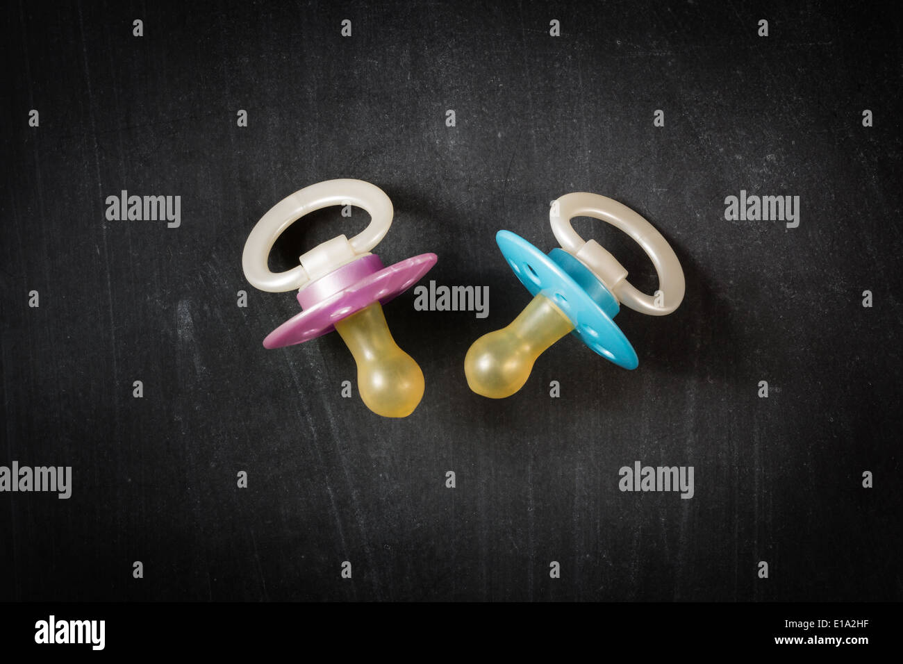 Blue and Pink Pacifier on Blackboard Stock Photo - Alamy