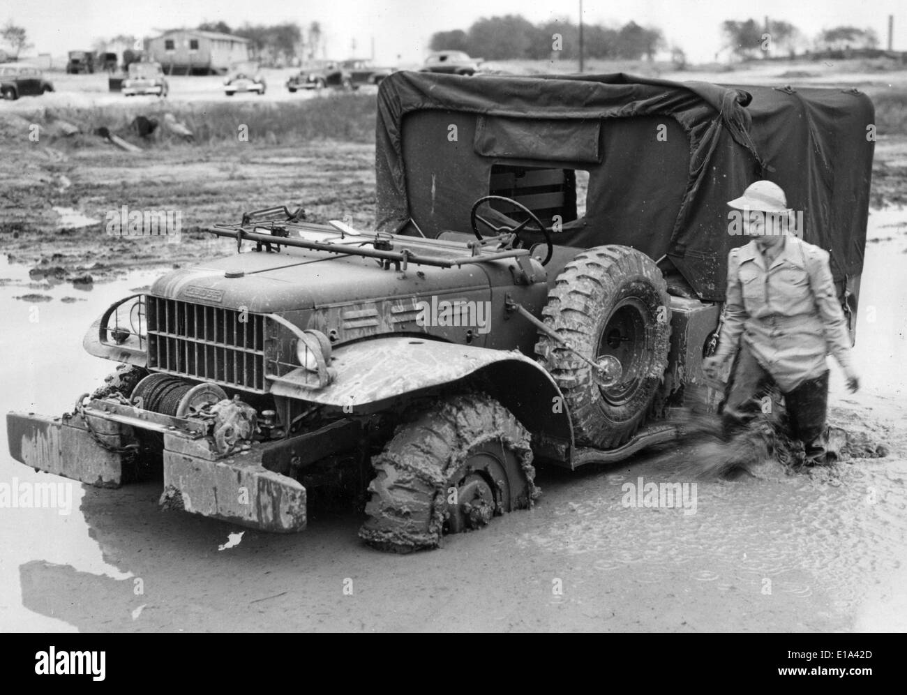 US Army WW2. A US woman soldier wades through water and mud in waders ...