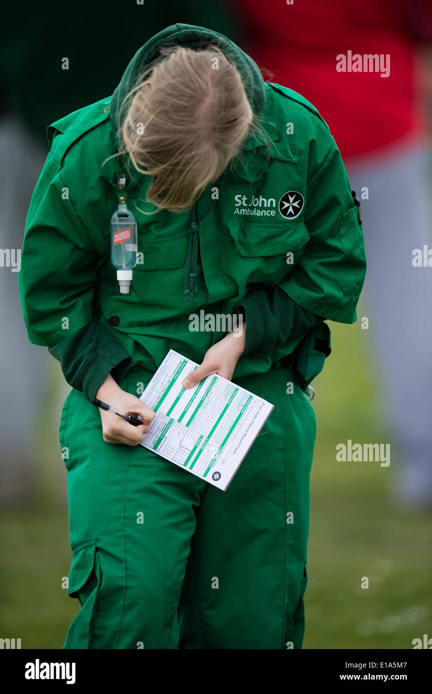 a St John Ambulance volunteer emergency first aid person filling first ...