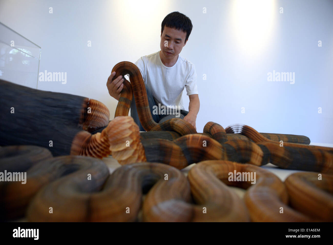 Singapore. 28th May, 2014. Chinese artist Li Hongbo prepares his work ...