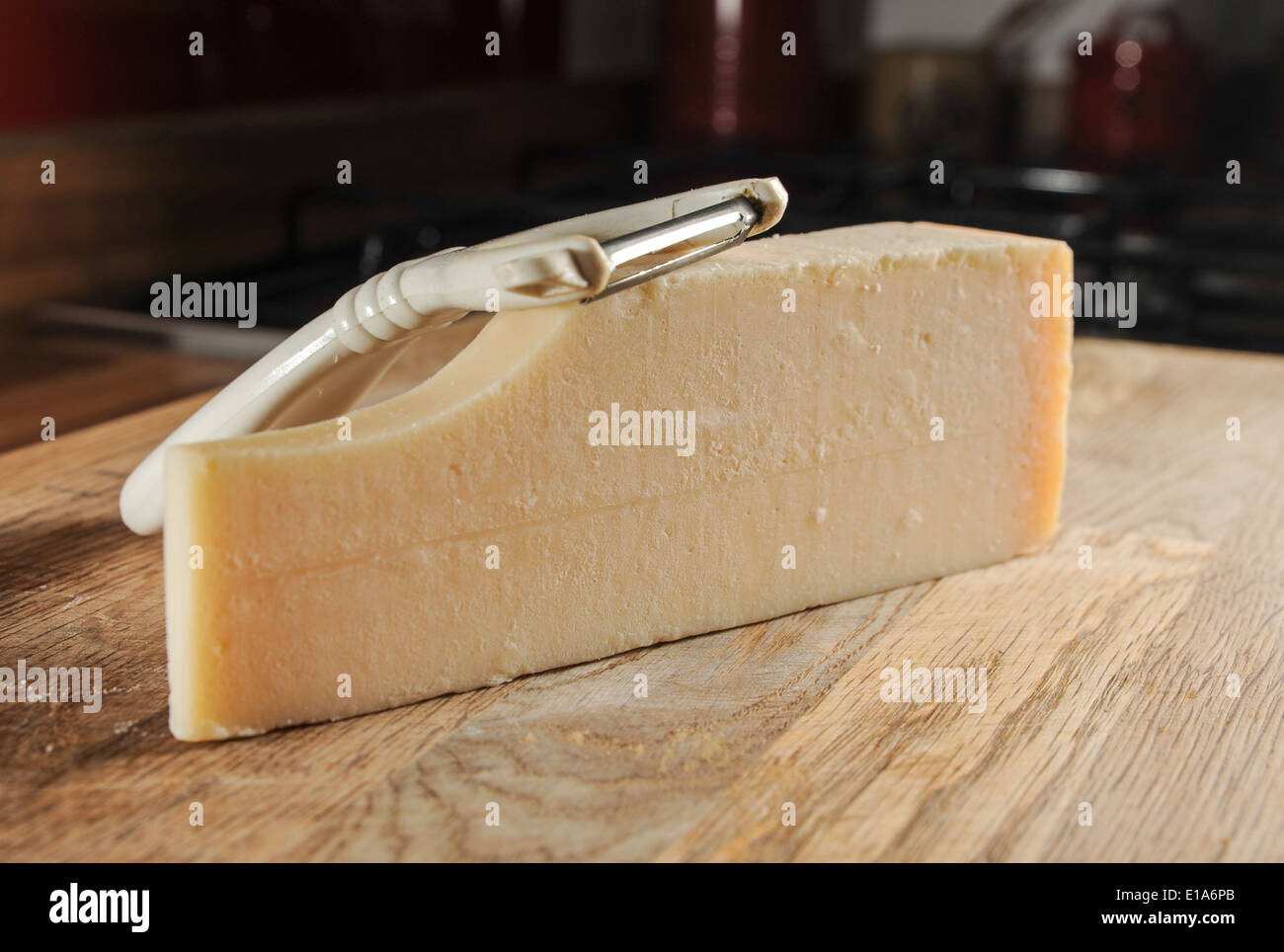 Parmesan cheese on wooden chopping board with slithers shaved off Stock ...