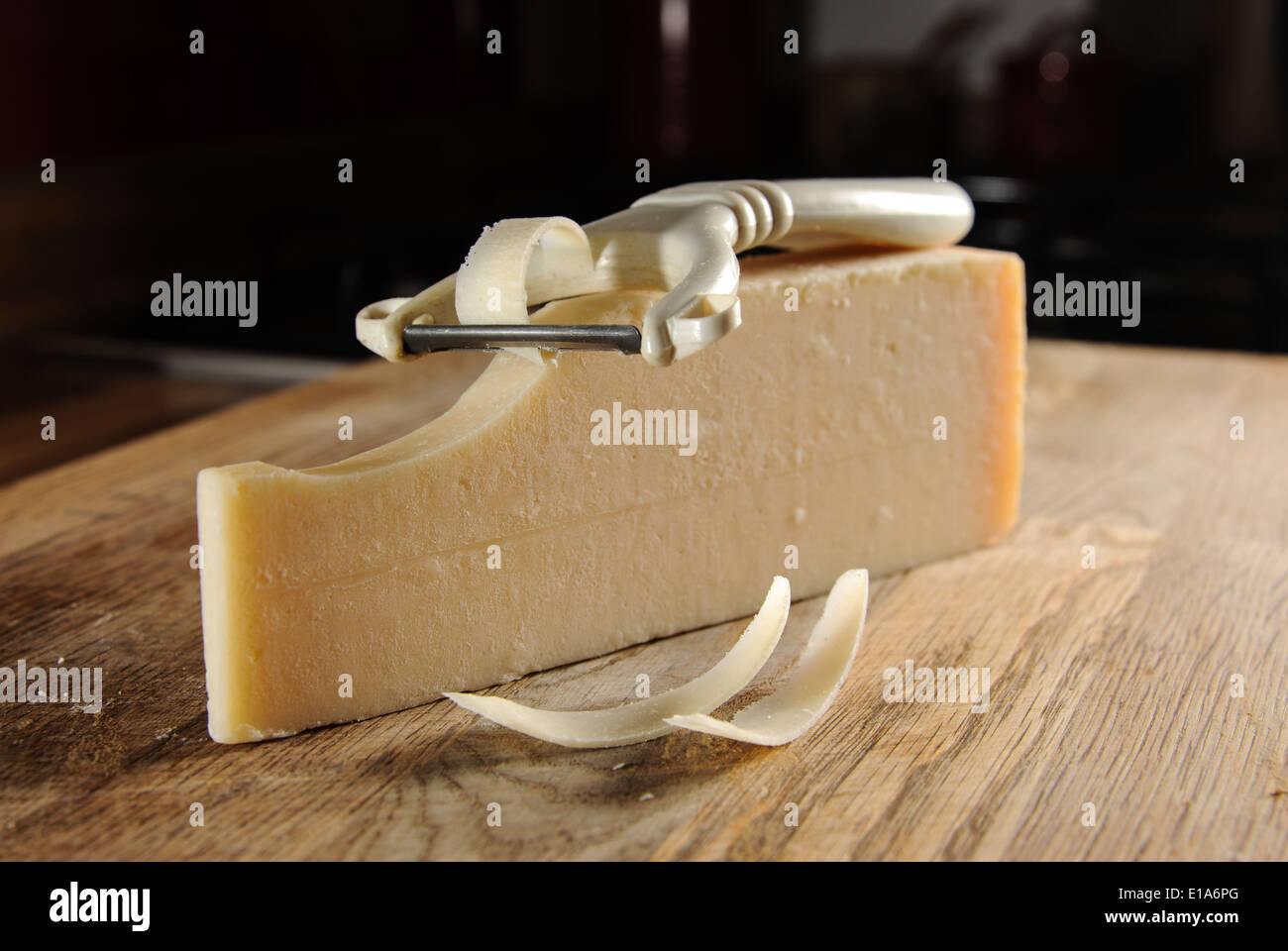 Parmesan cheese on wooden chopping board with slithers shaved off Stock ...