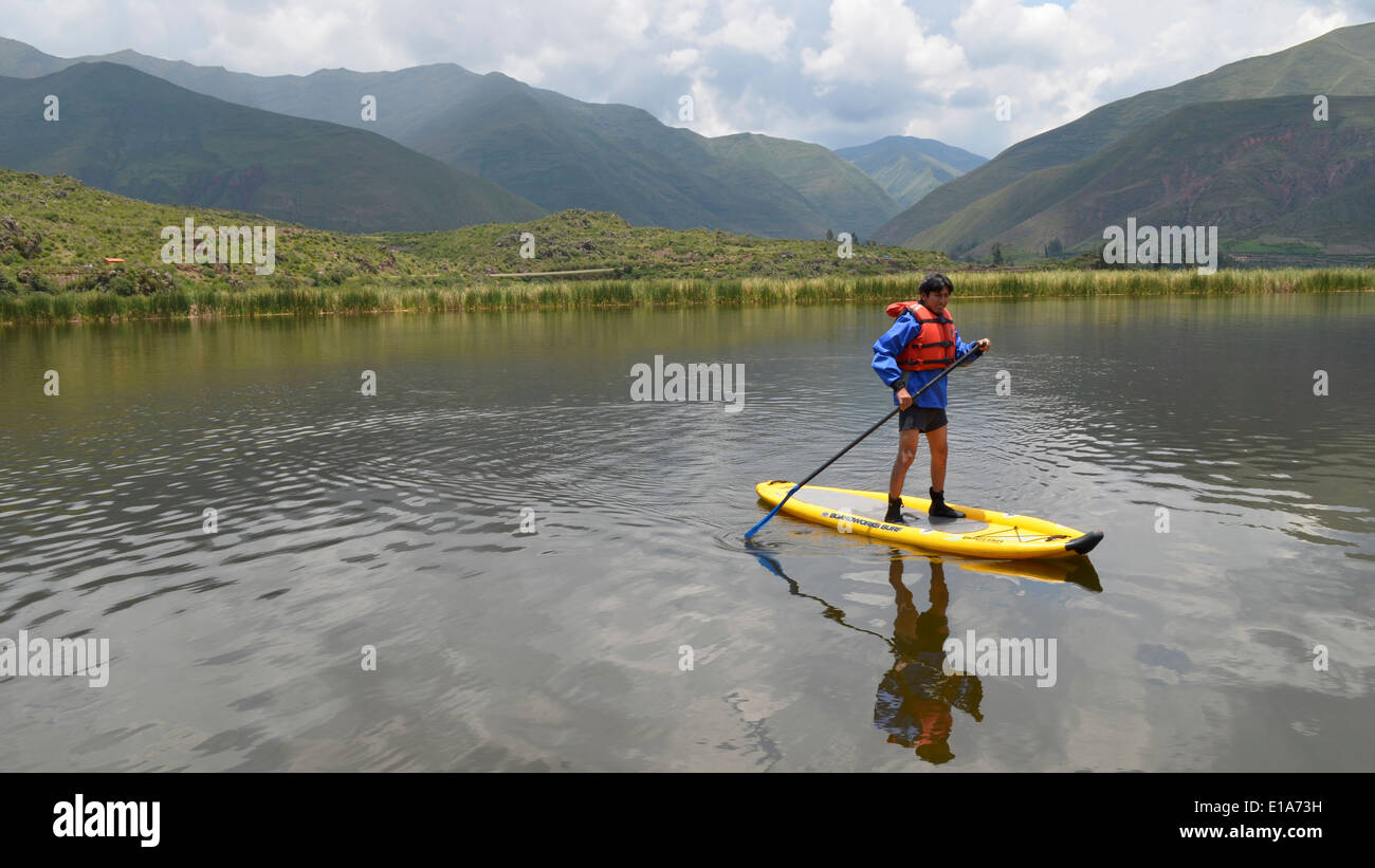 A man on his Stand Up Paddleboard (SUP) on Laguna Huacarpay near Cusco ...