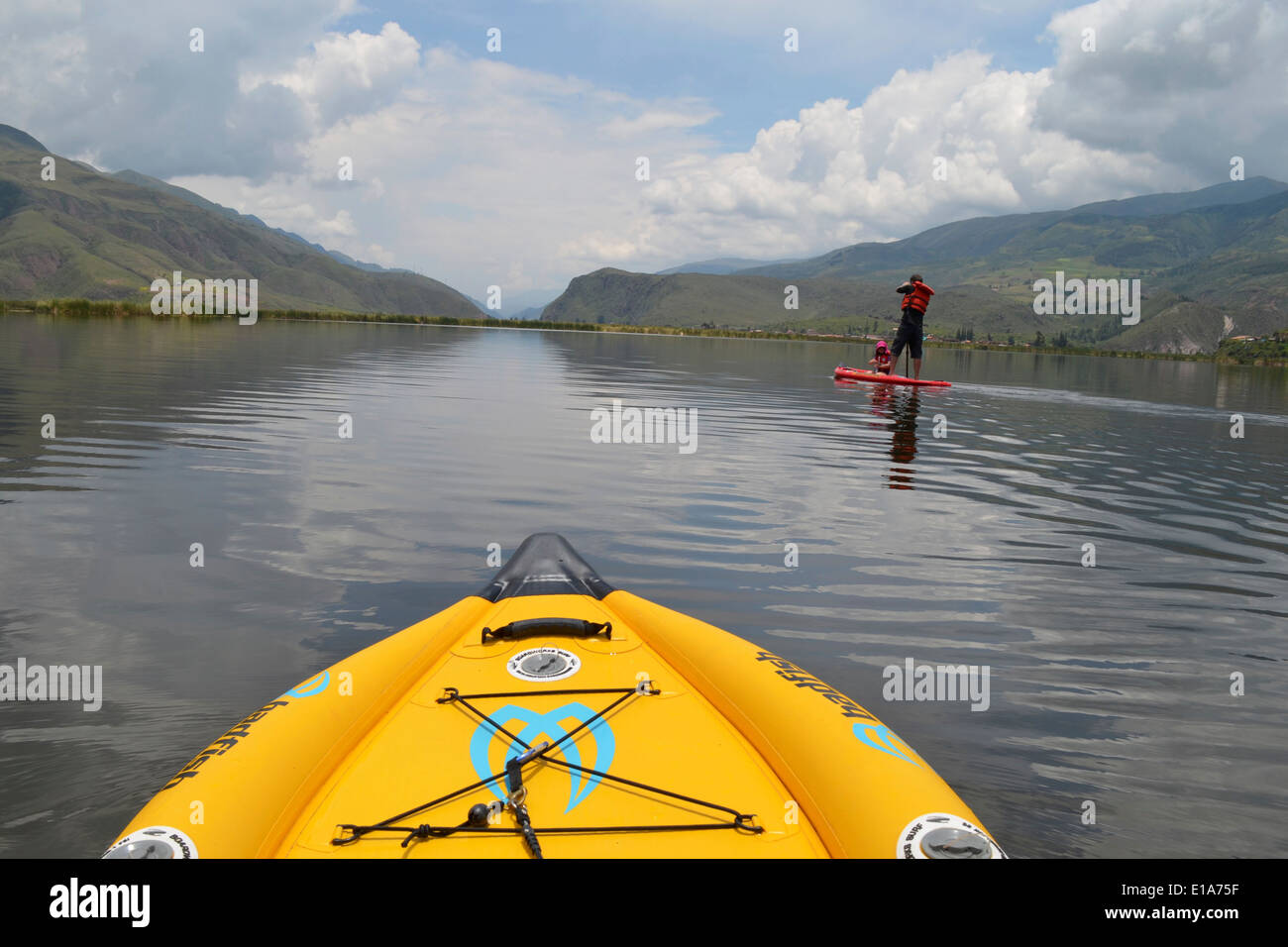 A man Stand Up Paddle Boarding (SUP) with his children on Laguna ...