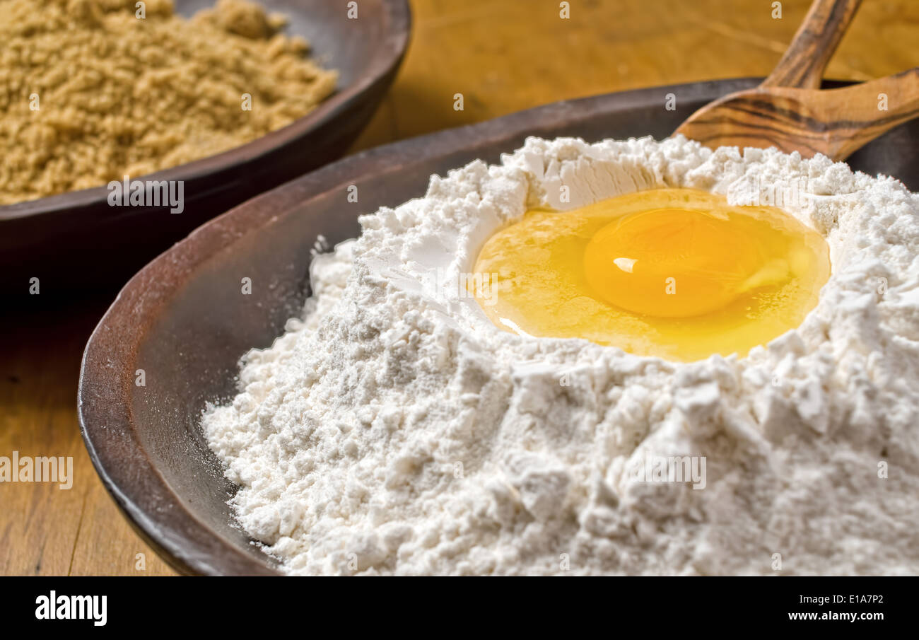 A bowl of flour with egg well Stock Photo - Alamy