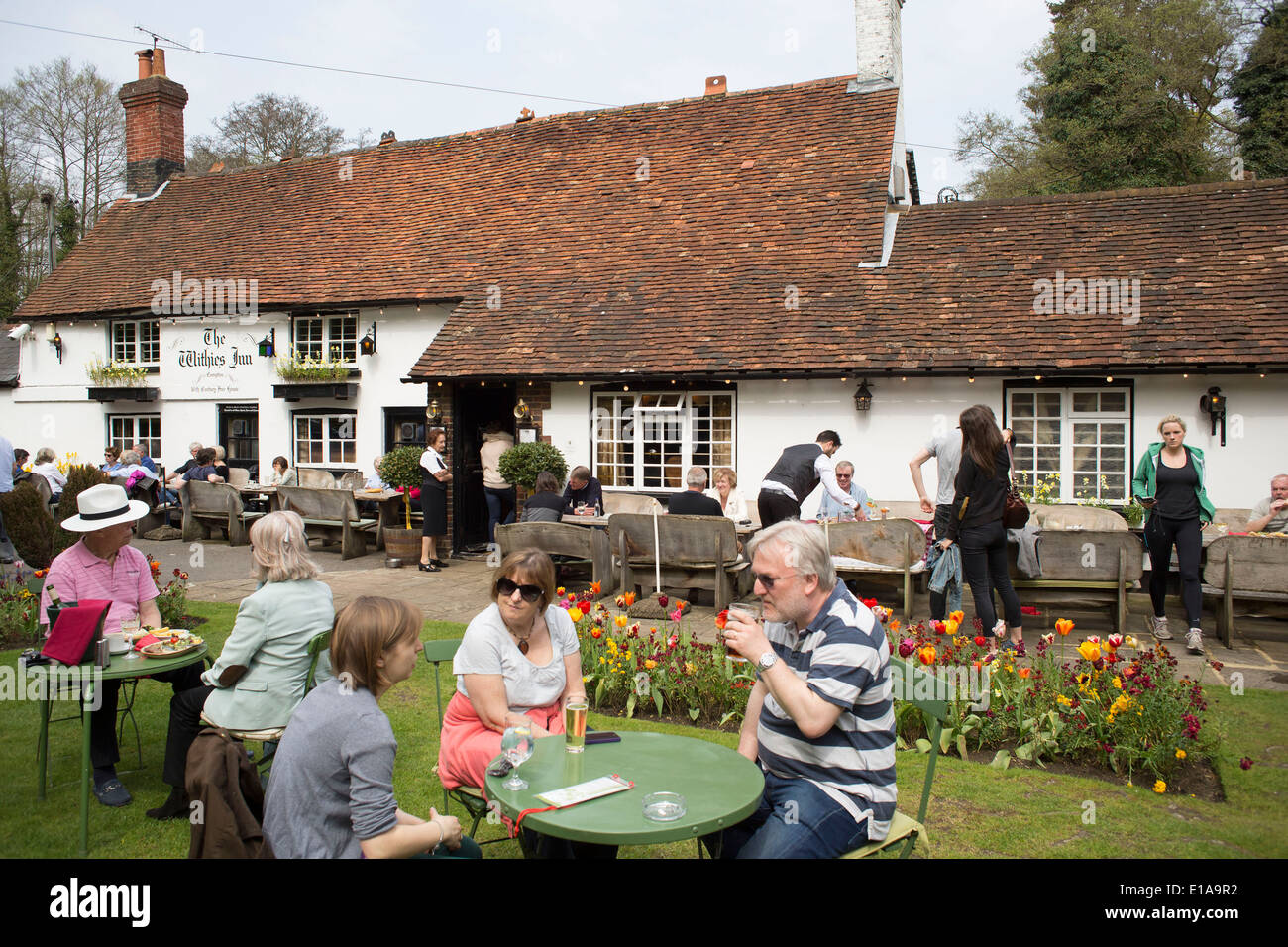 Customers in the garden at The Withies Inn traditional country pub in ...