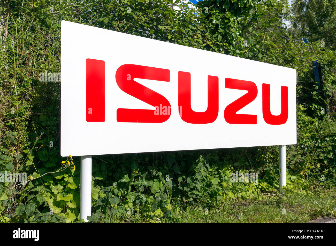 Bright red and white Isuzu sign Stock Photo - Alamy