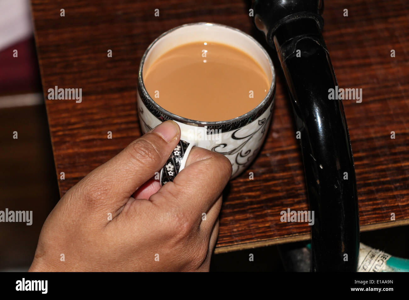 Hand holding hot cup of tea hi-res stock photography and images - Alamy