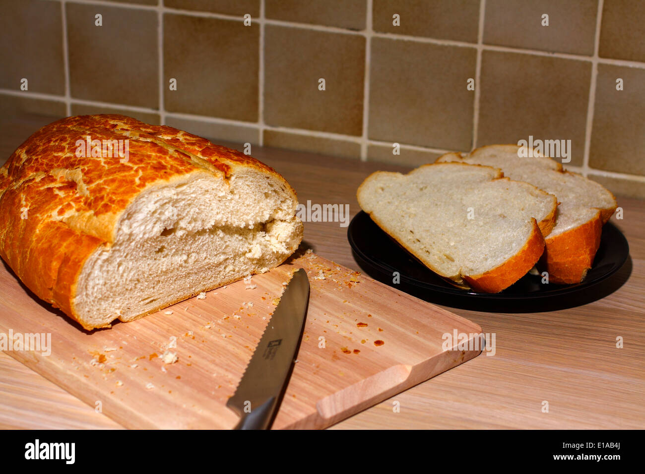 Fresh bread with bread knife Stock Photo - Alamy