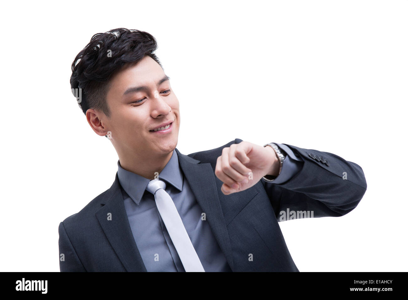 Businessman checking the time on wristwatch Stock Photo - Alamy