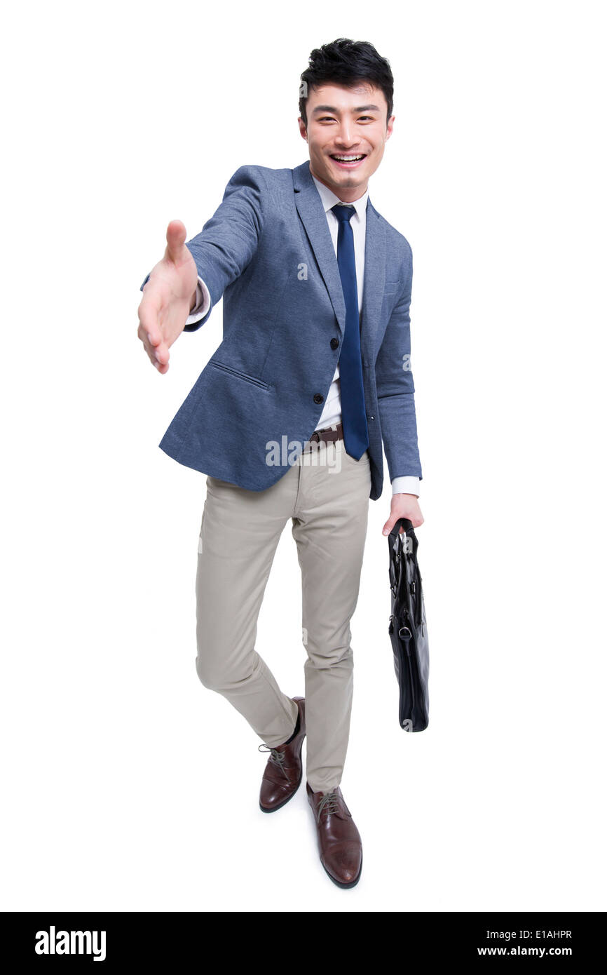 Businessman reaching out hand for handshake Stock Photo - Alamy