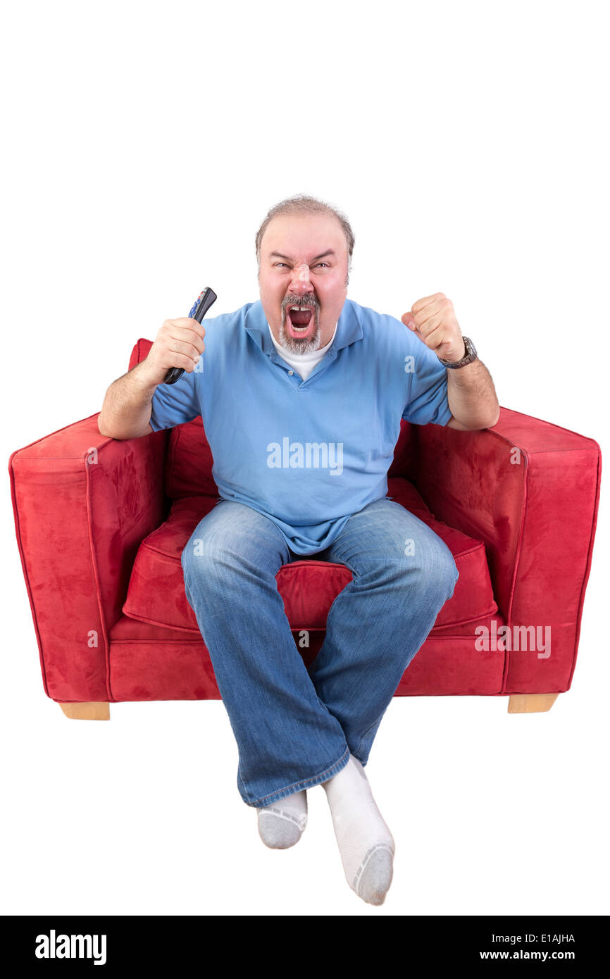 Middle-aged bearded man screaming at the television in excitement as he ...