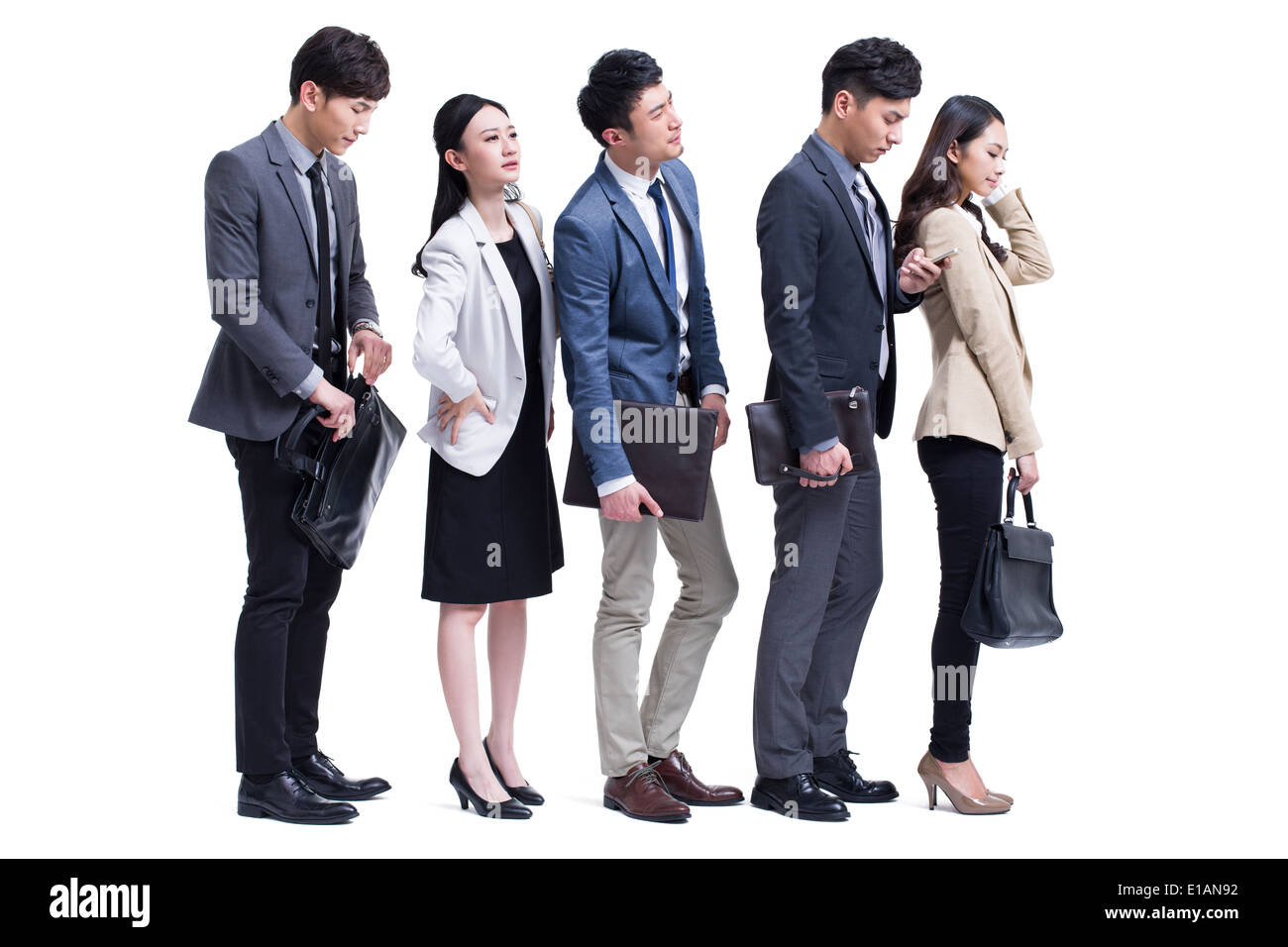 Young commuters waiting in line Stock Photo - Alamy