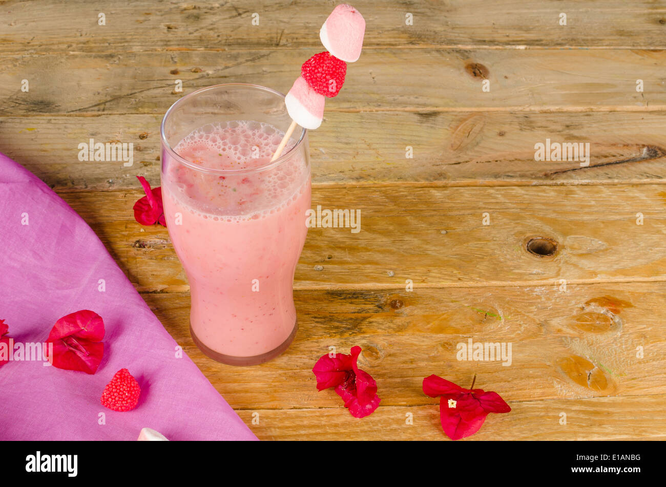 Glass with pink milkshake decorated with candy Stock Photo - Alamy