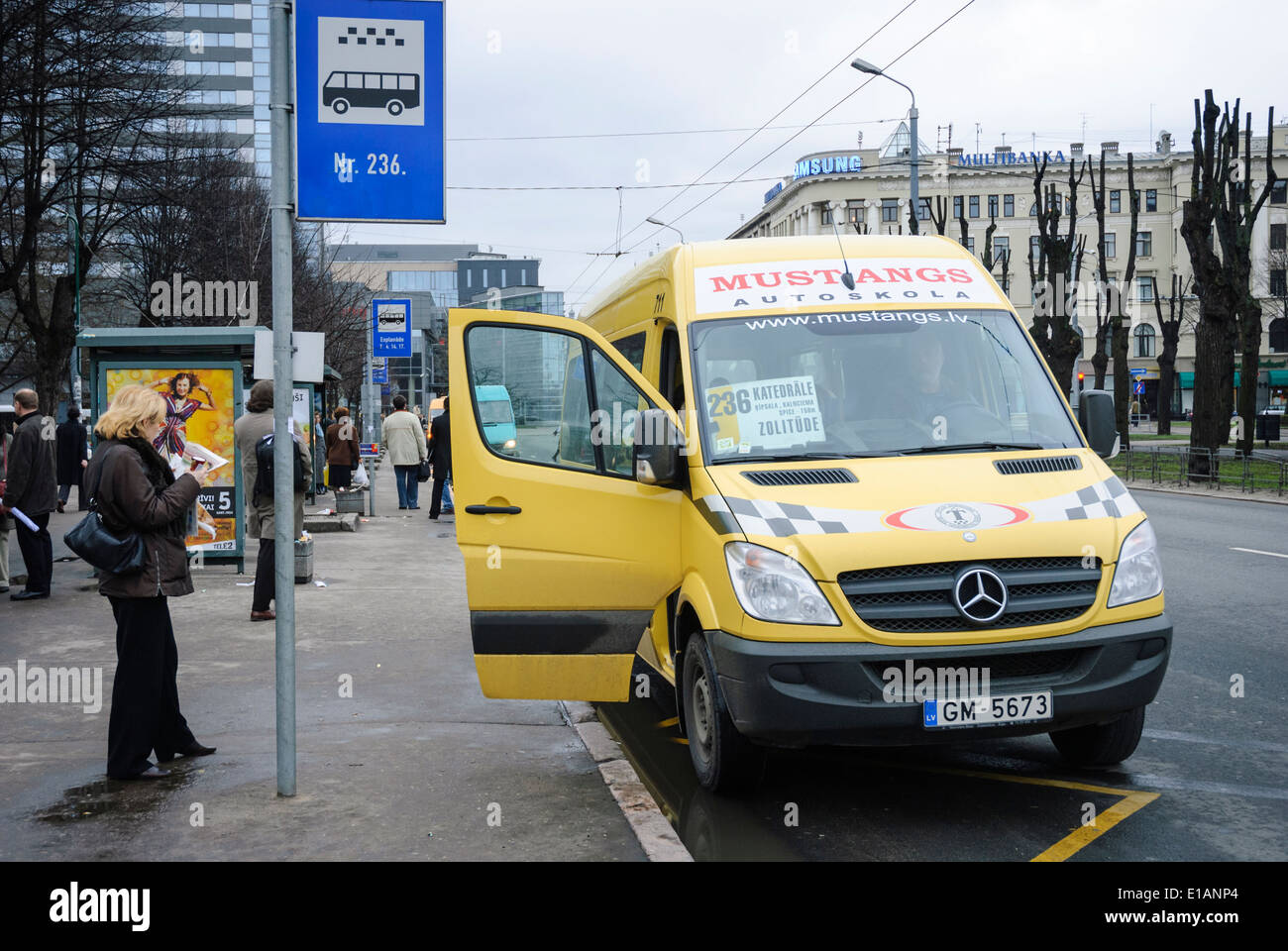 Small yellow minibus waiting for passengers: public transport bus ...