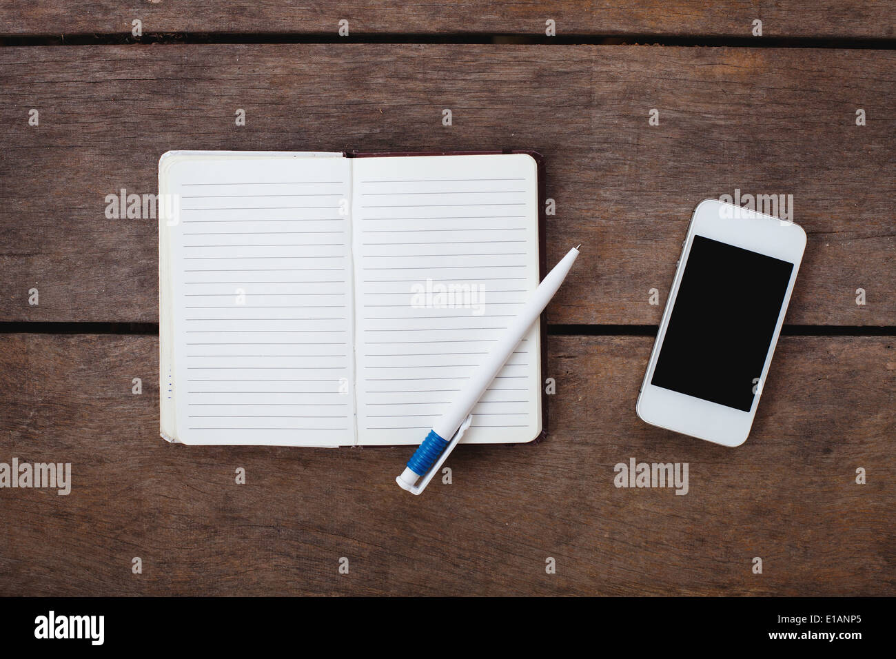 smartphone and notepad on the desk Stock Photo - Alamy