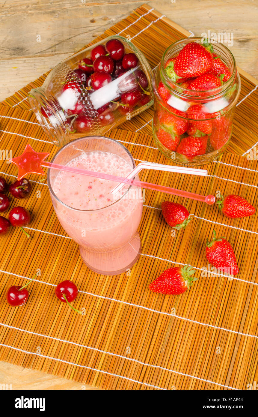 Glass with freshly made strawberry and cherry milkshake Stock Photo - Alamy