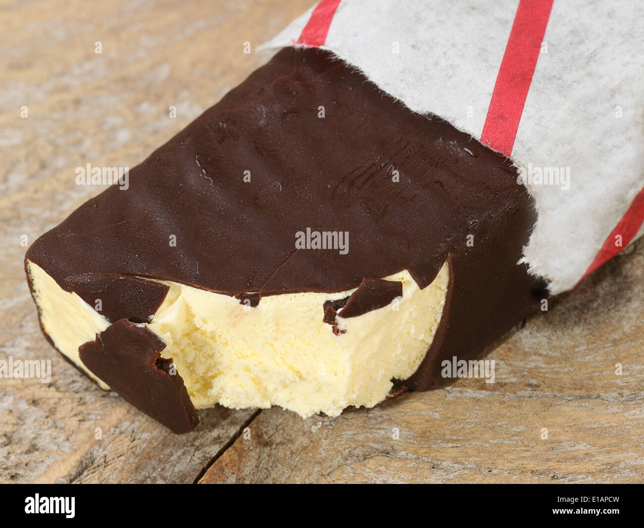 dark chocolate coated ice cream bar in a paper wrapper Stock Photo - Alamy
