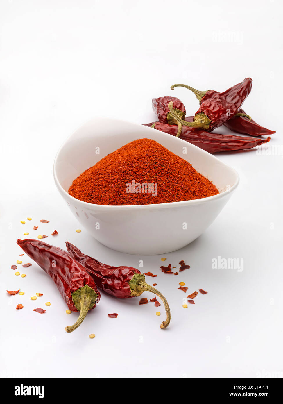 Ground red pepper bowl on white background Stock Photo - Alamy