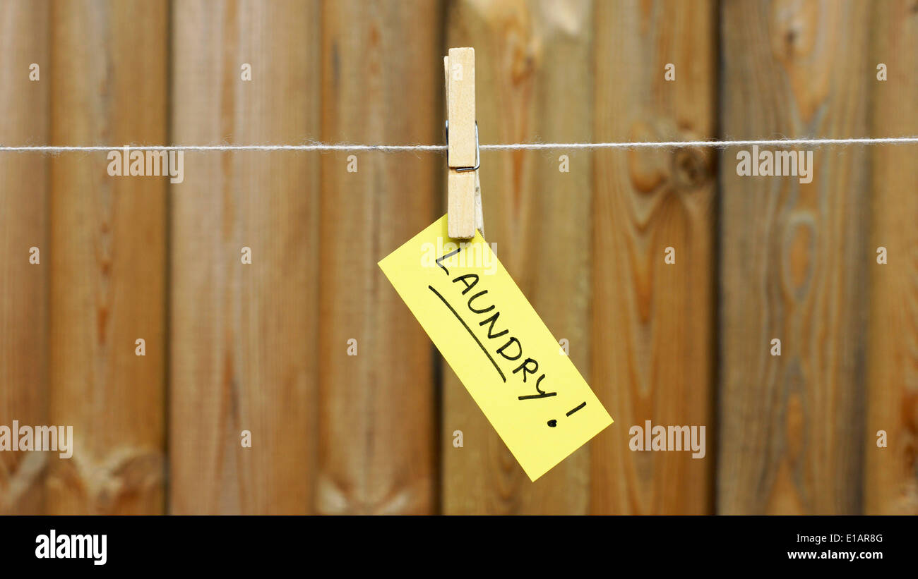 Laundry written on a memo at the clothesline Stock Photo - Alamy