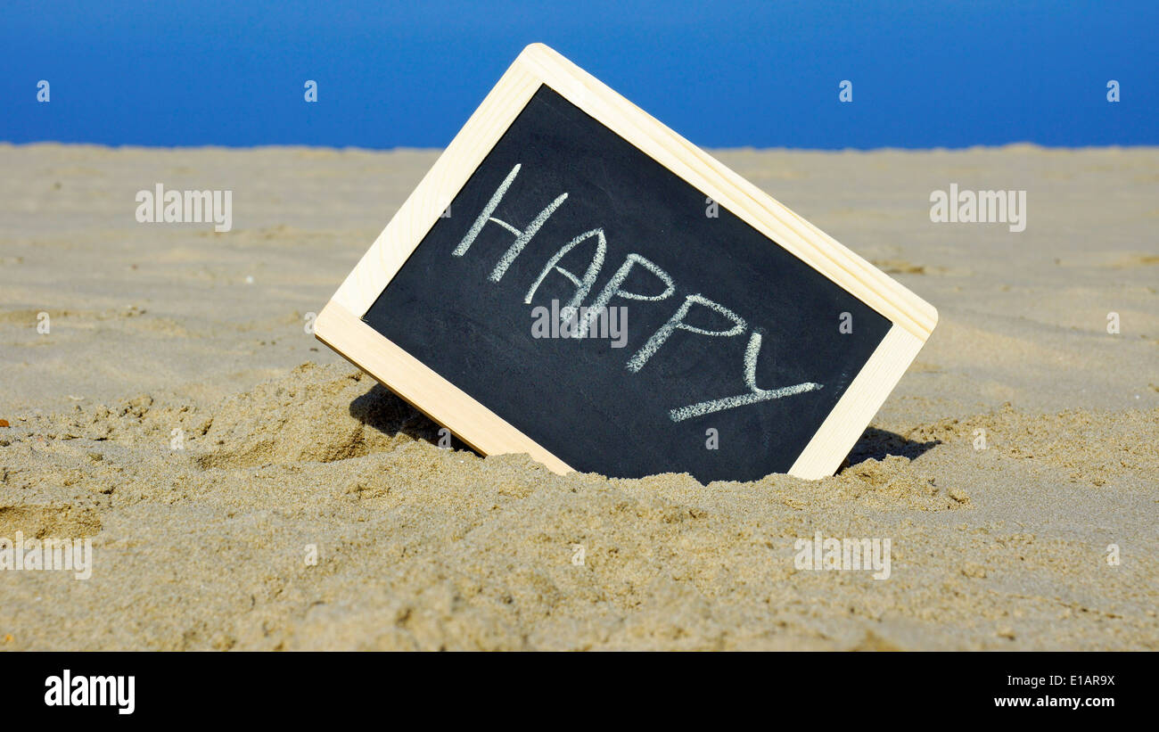 Happy written on a chalkboard in the sun Stock Photo - Alamy