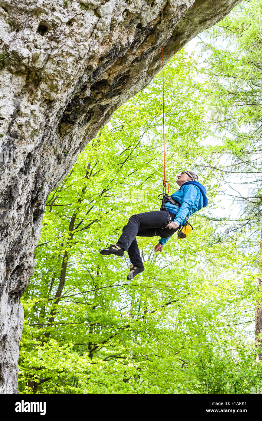 Female climber, woman climbing rock, abseiling from the top Stock Photo ...