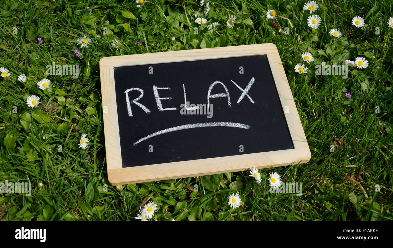 Relax written on a chalkboard in the sun Stock Photo - Alamy