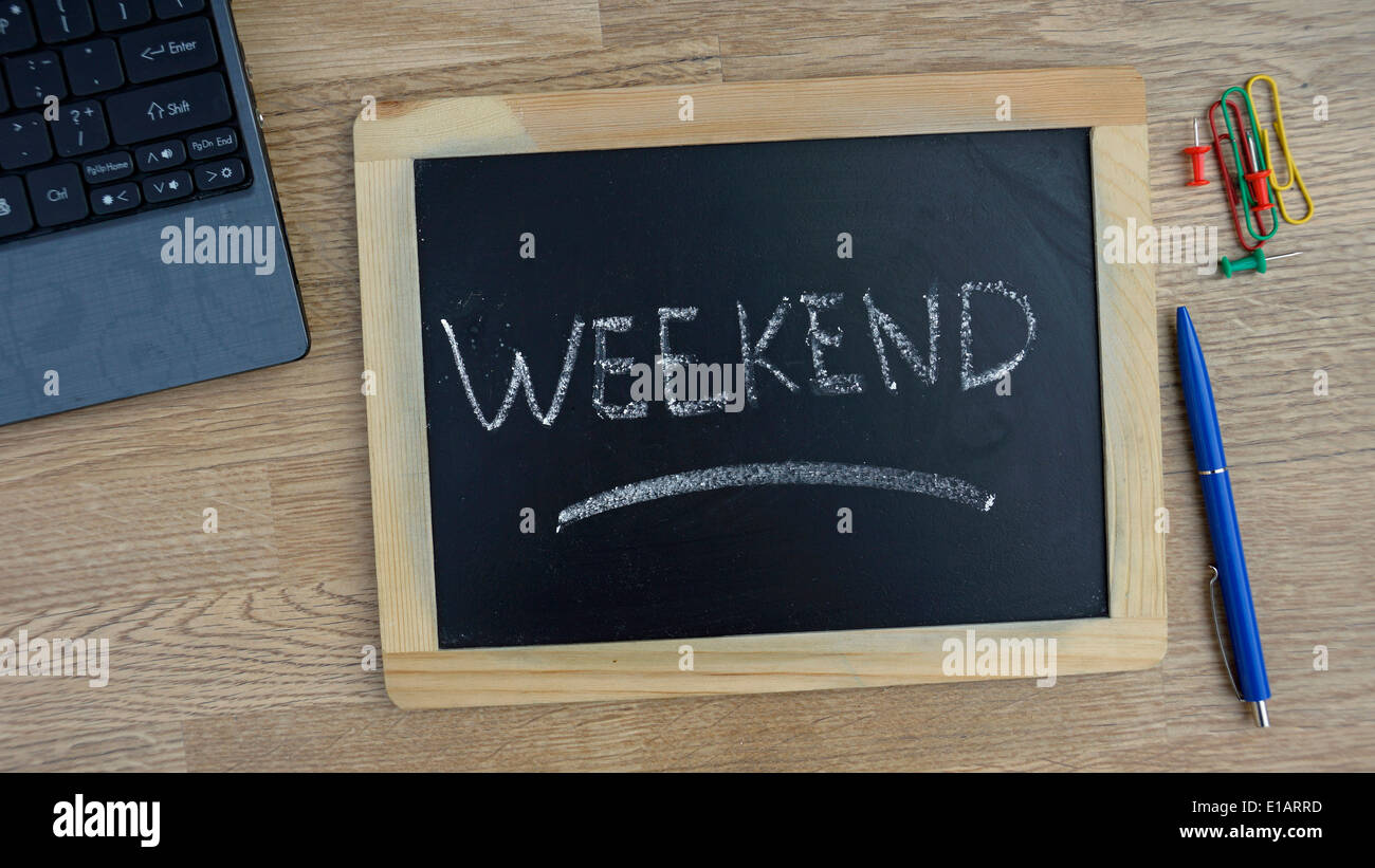 weekend written on a chalkboard at the office Stock Photo - Alamy