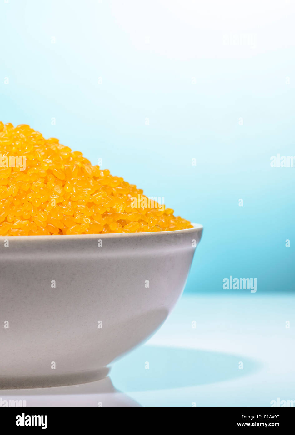 the raw golden rice in the bowl Stock Photo - Alamy