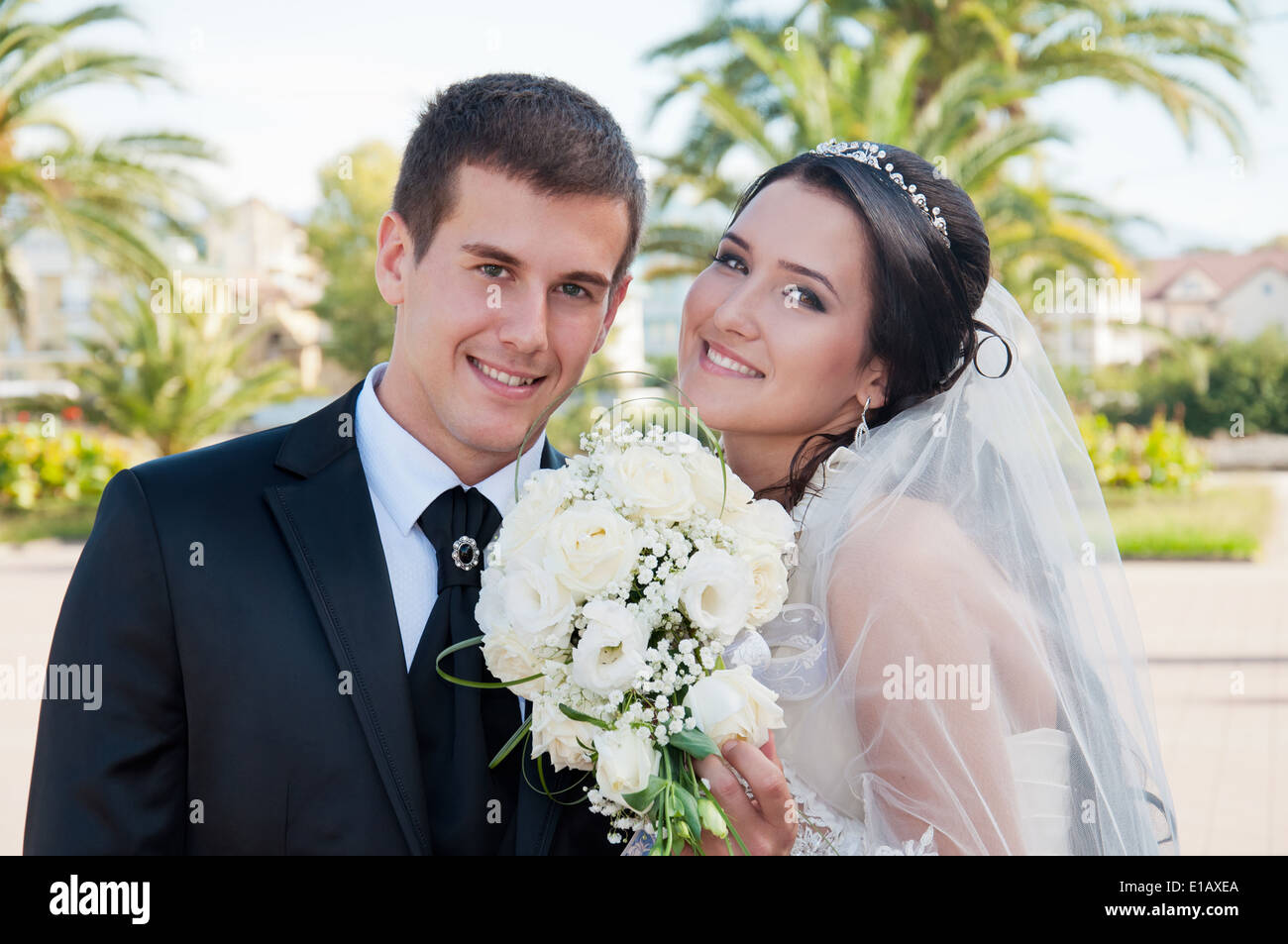 Wedding day. bridegroom and bride on background of the green palms ...