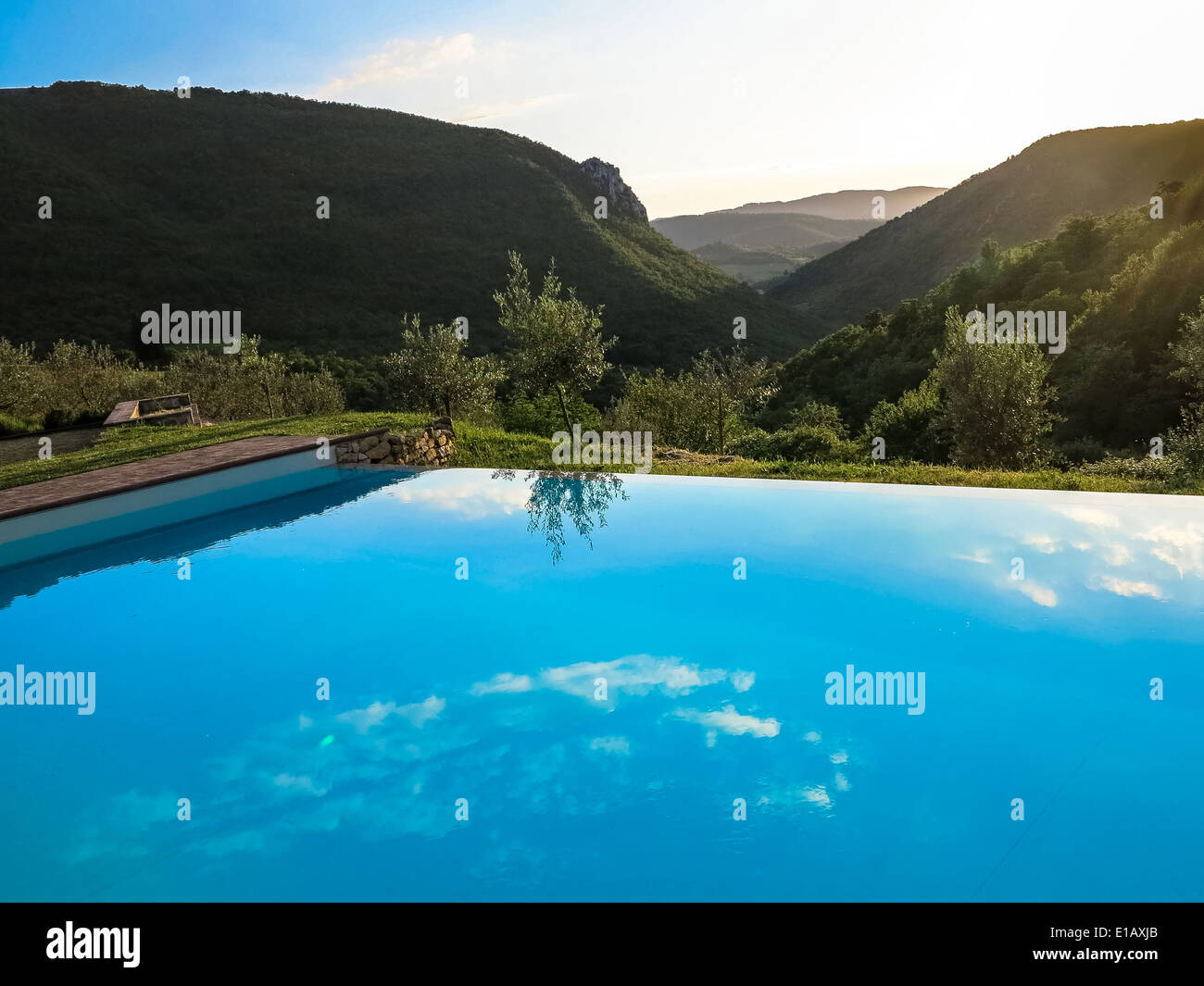 The horizon and reflections in an infinity swimming pool against a ...