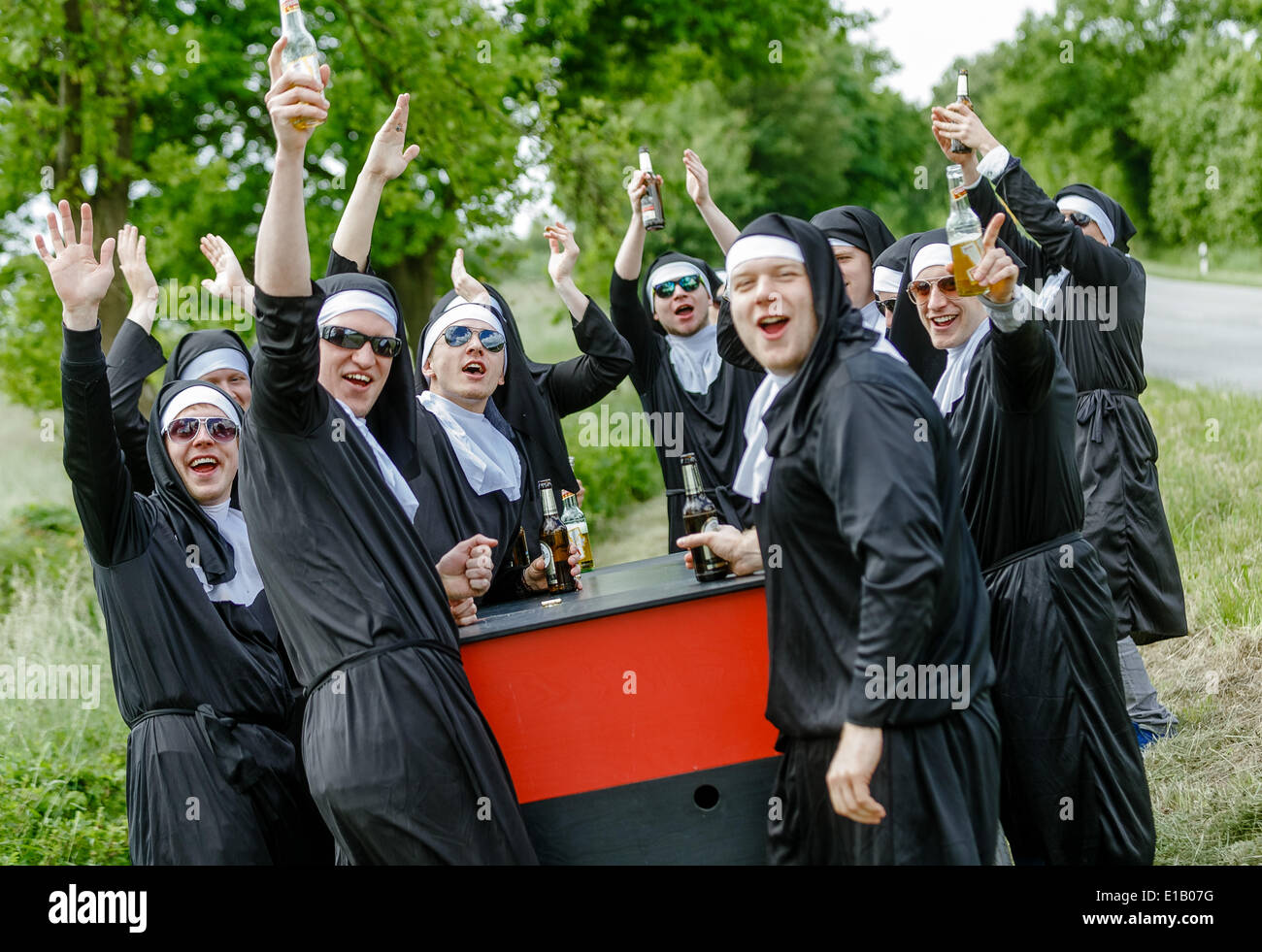 Timmerhorn, Germany. 29th May, 2014. Young men in nun costumes march ...