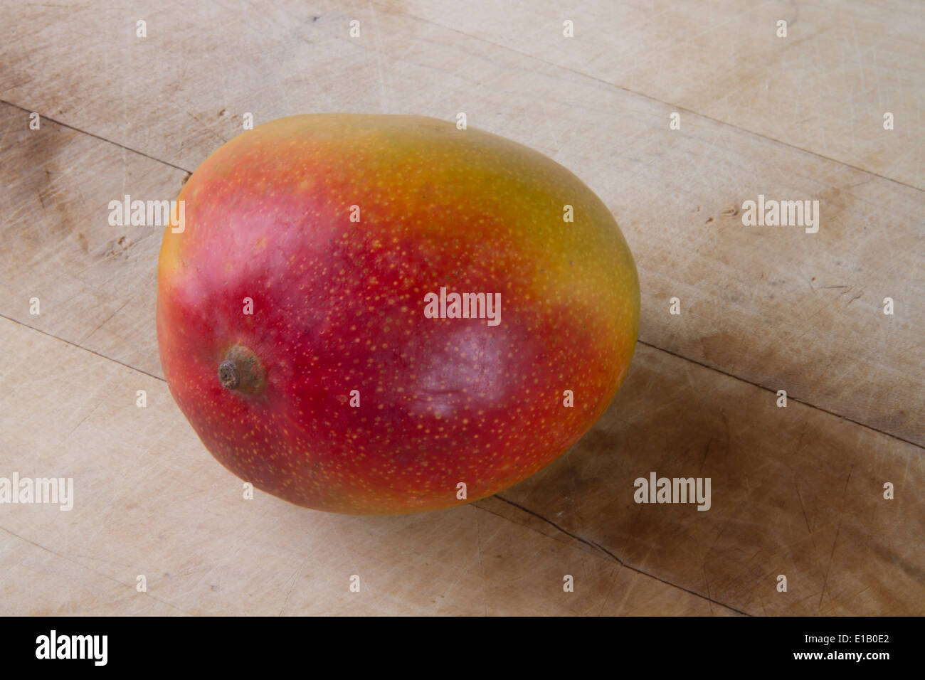 Alfonso mango fruit on a wooden block Stock Photo - Alamy