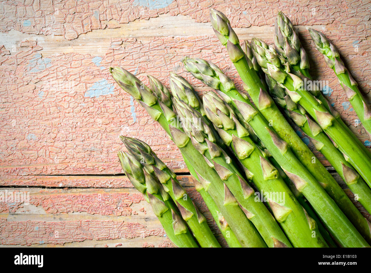 top view of green asparagus on old wooden table Stock Photo - Alamy