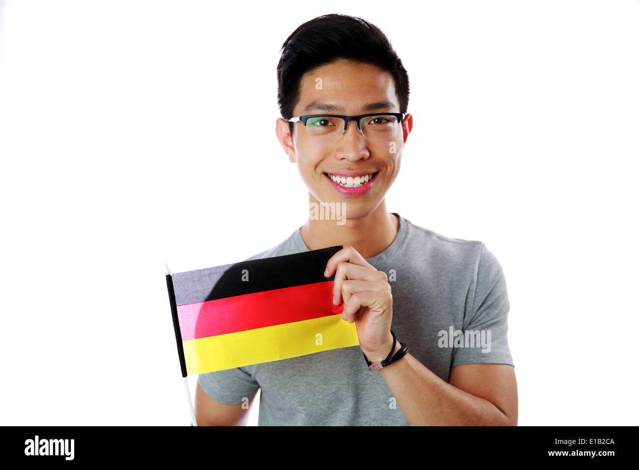 Happy asian student holding flag of Germany over white background Stock ...