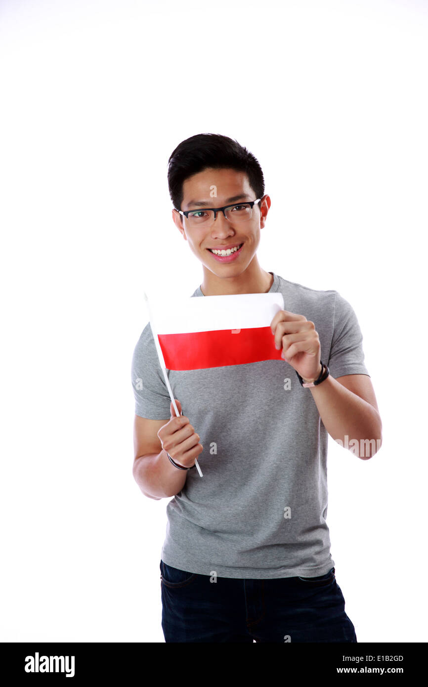 Smiling asian man holding flag of Poland over white background Stock ...